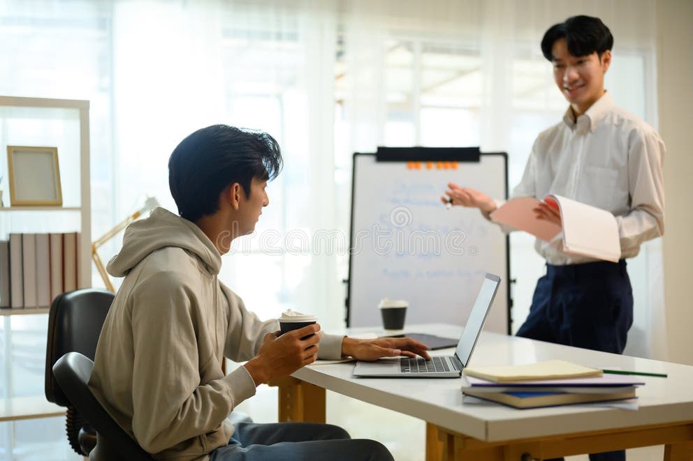 Smiling Tutor Standing by a Whiteboard To Explaining Grammar Rules for ...