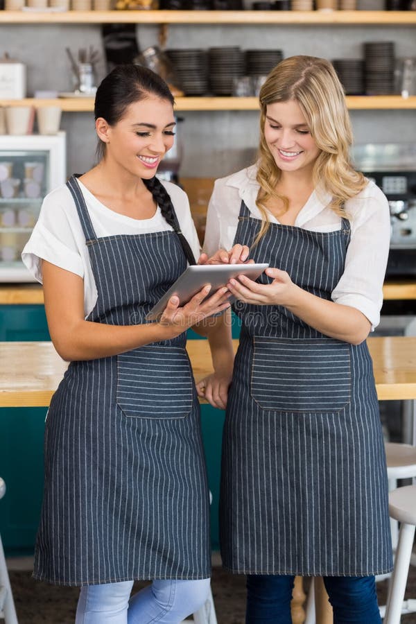 Smiling Two Waitresses Using Digital Tablet Stock Photo - Image of ...