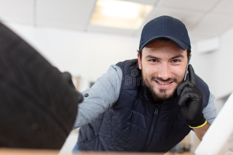 Smiling Tyre Mechanic Talking on Telephone Stock Image - Image of ...