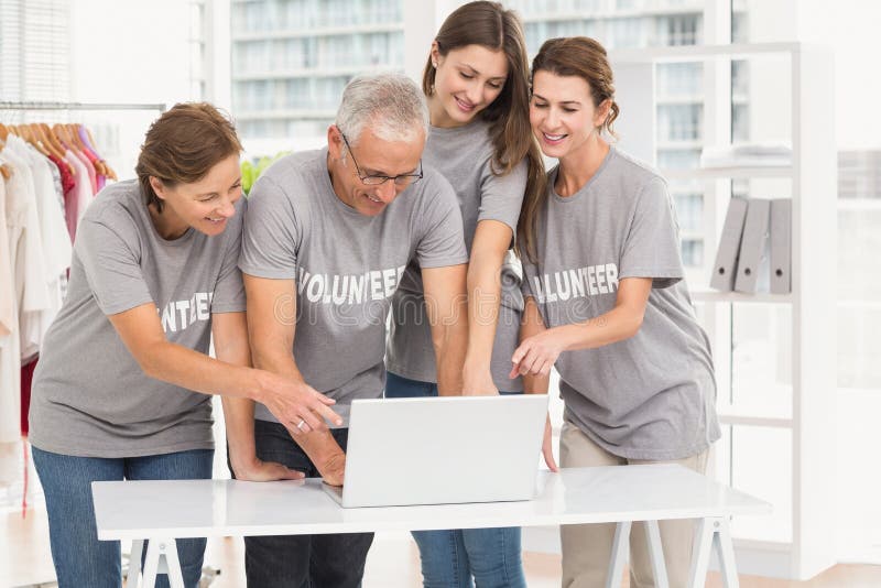 Smiling Volunteers Pointing on Laptop Stock Image - Image of coworkers ...
