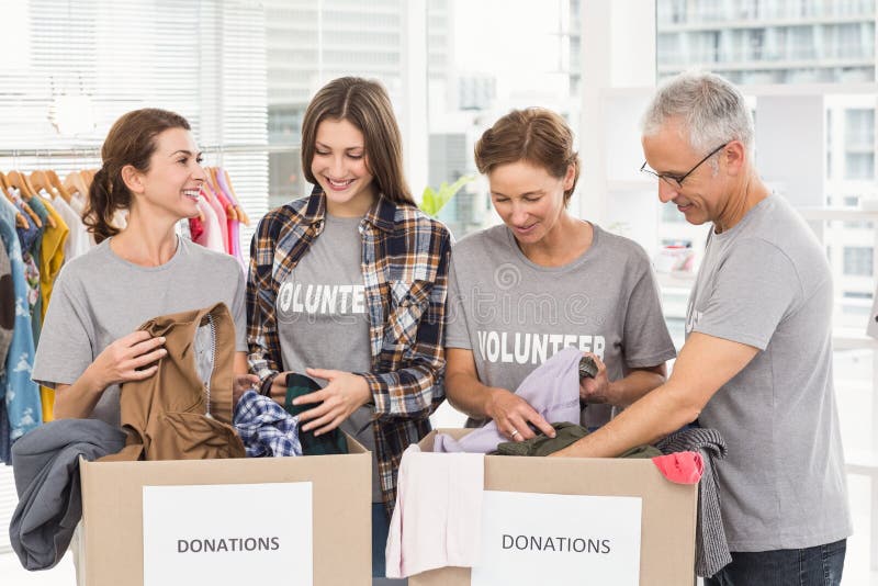 Smiling Volunteers Sorting Donation Boxes Stock Image - Image of ...
