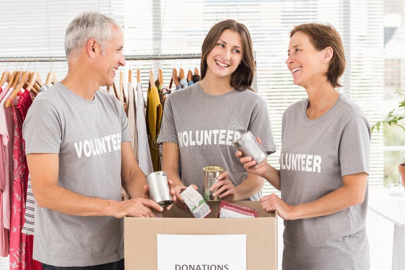 Smiling Volunteers Sorting Donations Stock Image - Image of colleagues ...