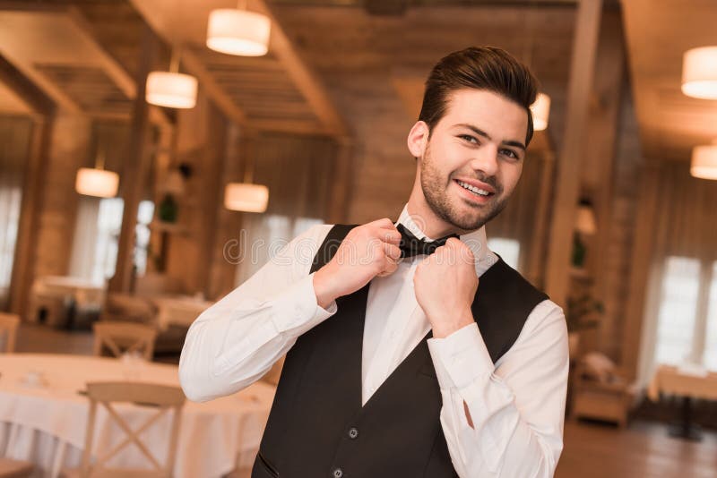 Waiter fixing bow tie stock image. Image of wooden, occupation - 104984147