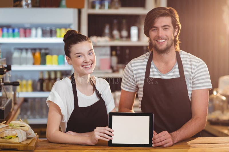Smiling Waiter and Waitress Interacting while Using Digital Tablet ...