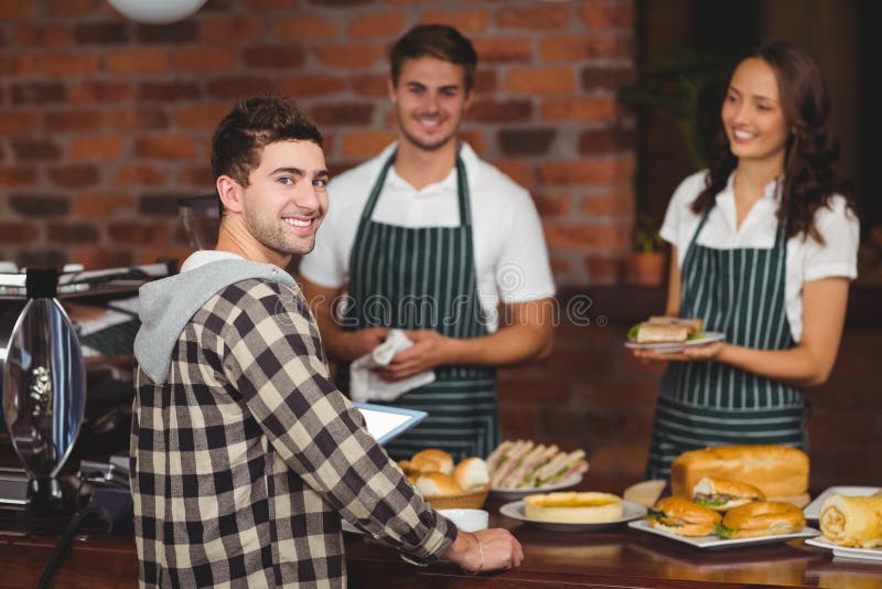 Smiling Waiters and Customer Looking at the Camera Stock Photo - Image ...