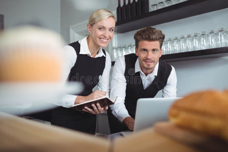 Smiling Waiters Serving a Client Stock Image - Image of colleagues ...