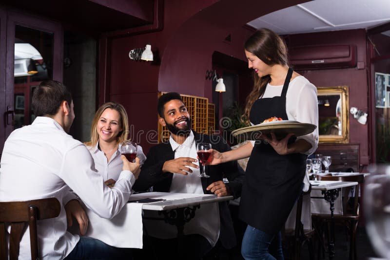 Smiling Waitress and Guests at the Table Stock Image - Image of ...