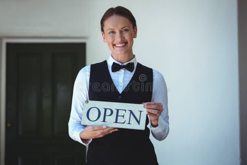Smiling Waitress Holding Open Sign Stock Photo - Image of holding ...