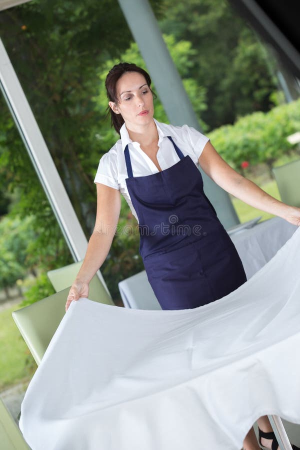 Smiling Waitress Setting Table in Restaurant Stock Image - Image of ...