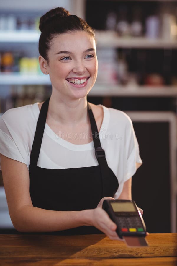 Smiling Waitress Showing Credit Card Machine Stock Image - Image of ...