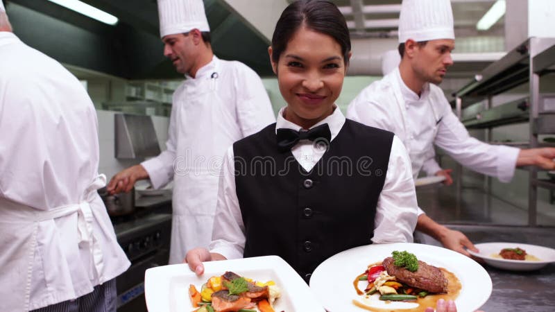 Smiling Waitress Showing Two Dishes To Camera Stock Video - Video of ...
