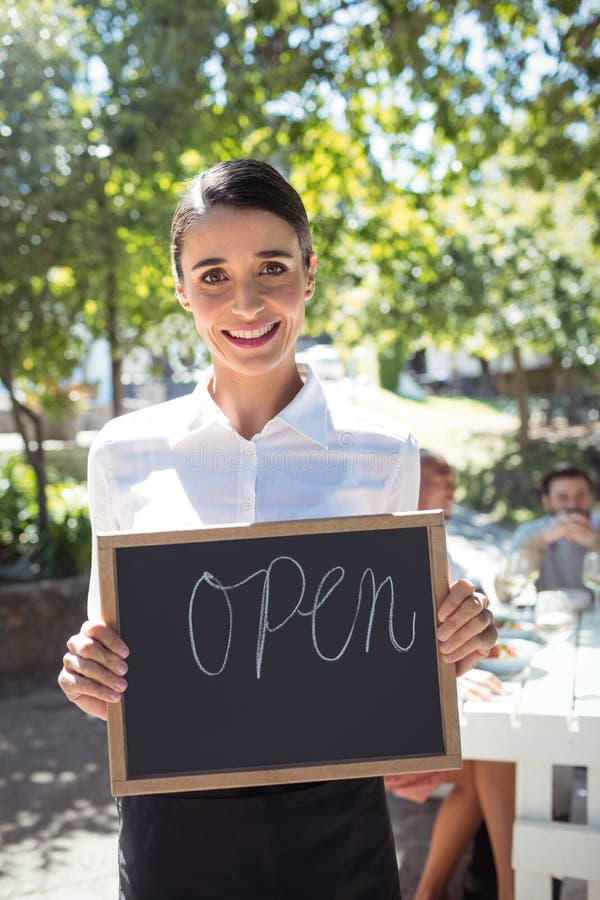 Smiling Waitress Standing with Open Sign Board Stock Photo - Image of ...