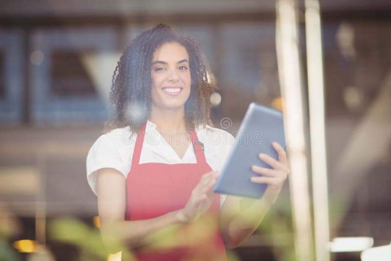 Waitress Using Digital Tablet while Waiter Preparing Coffee in ...