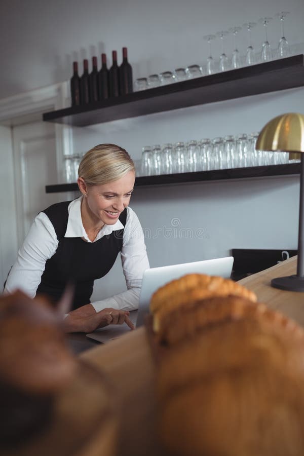 Waitress Using Digital Tablet while Waiter Preparing Coffee in ...
