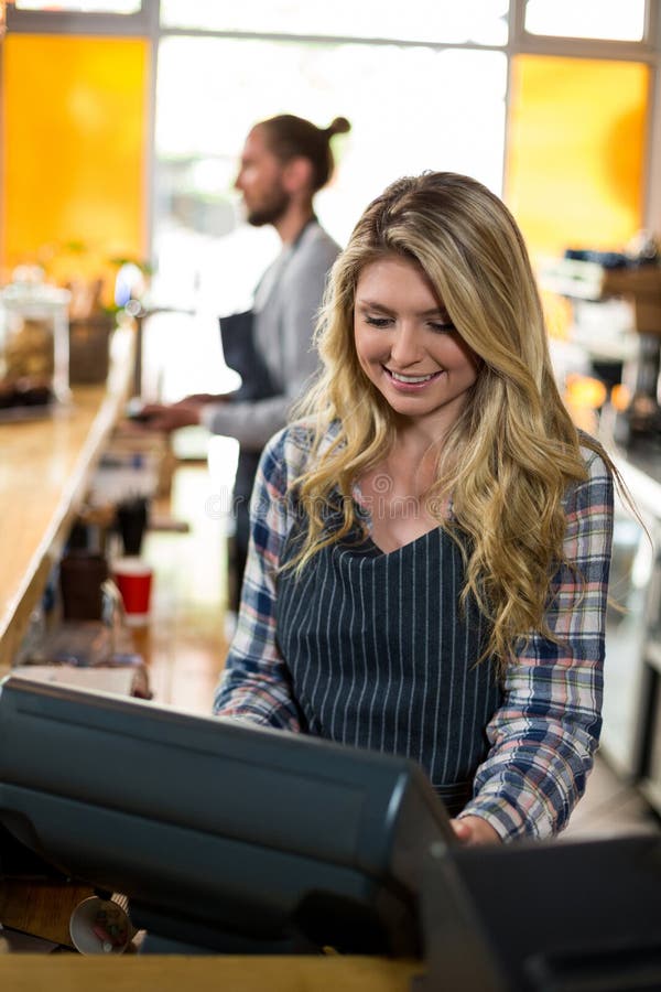 Smiling Waitress Working on Computer at Counter Stock Image - Image of ...