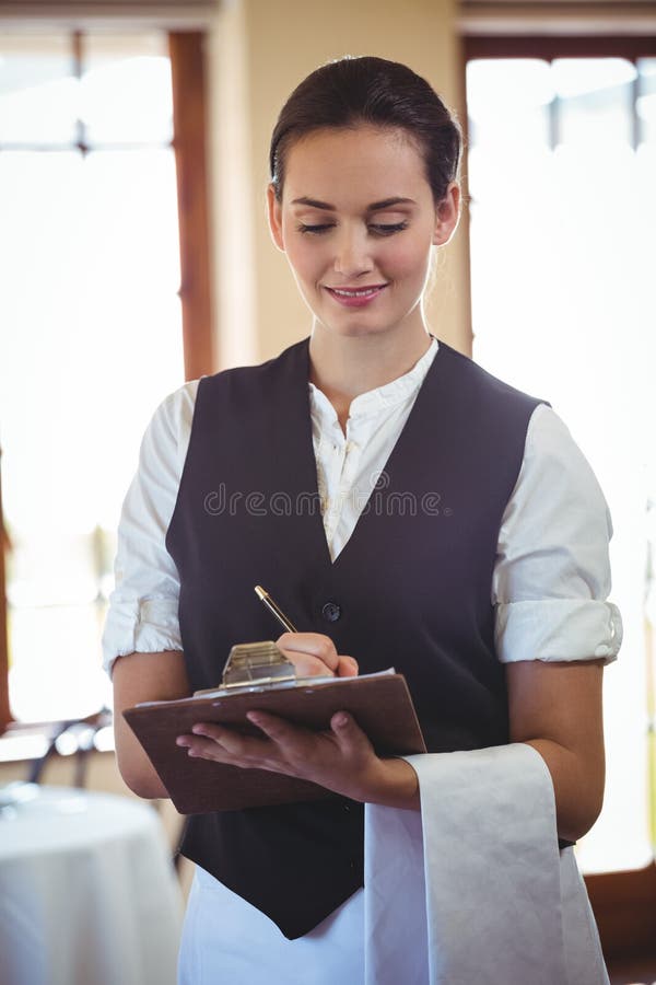 Smiling Waitress Writing on Clipboard Stock Image - Image of worker ...