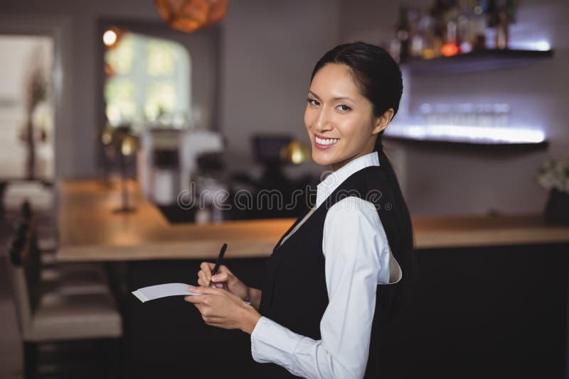 Smiling Waitress Writing Order on Notepad Stock Photo - Image of ...