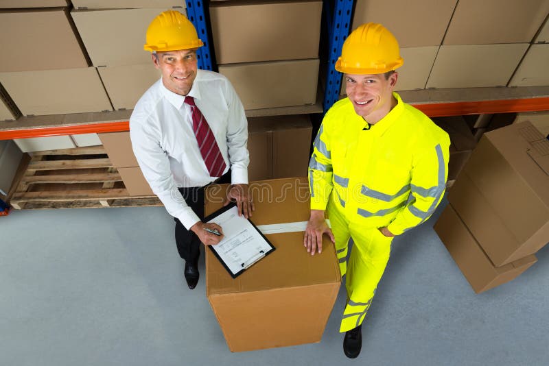 Smiling Warehouse Manager Checking Inventory Stock Photo - Image of ...