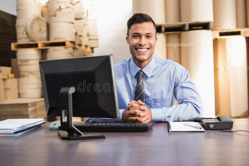 Smiling Warehouse Manager with Laptop at Desk Stock Photo - Image of ...