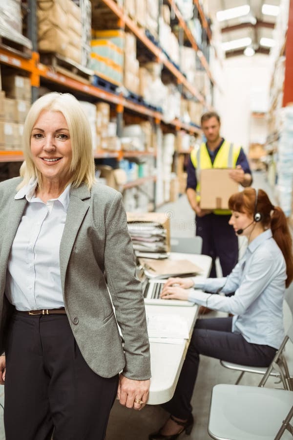 Smiling Warehouse Manager Leaning on Desk Stock Image - Image of ...