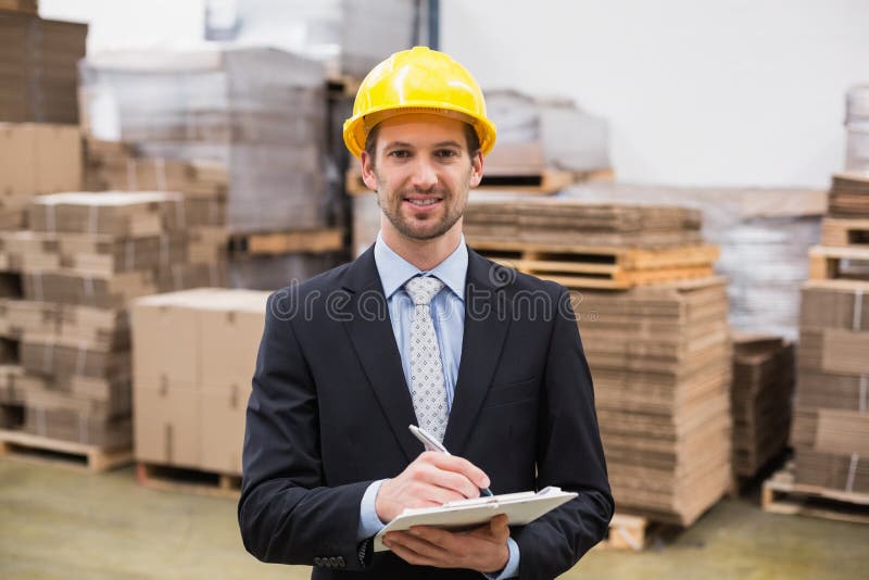 Smiling Warehouse Manager Writing on Clipboard Stock Image - Image of ...