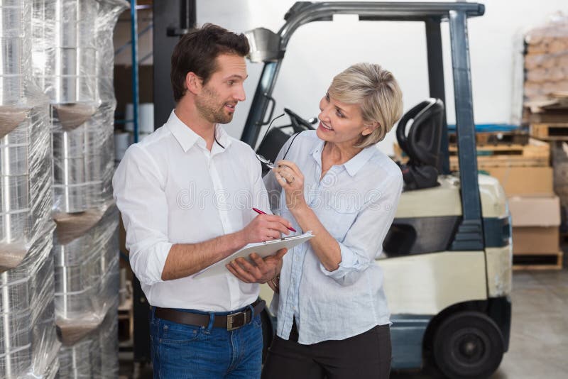 Smiling Warehouse Managers Working on Clipboard Stock Image - Image of ...