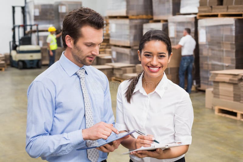 Smiling Warehouse Managers Working Together Stock Image - Image of four ...