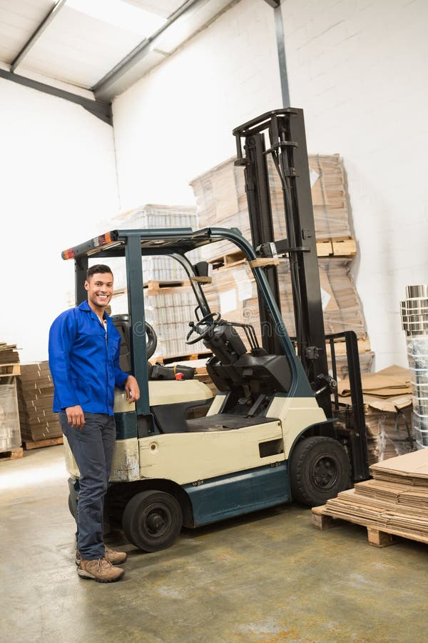 Smiling Warehouse Worker Leaning Against Forklift Stock Image - Image ...