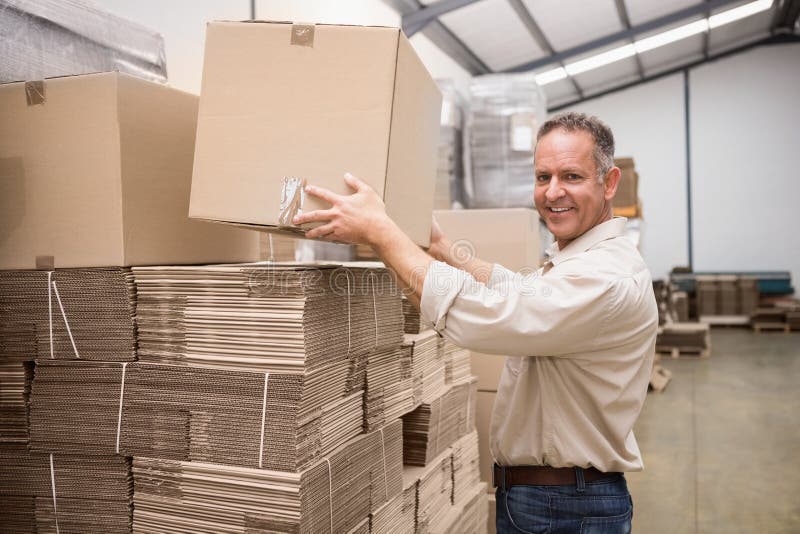 Smiling Warehouse Worker Taking a Box Stock Image - Image of business ...