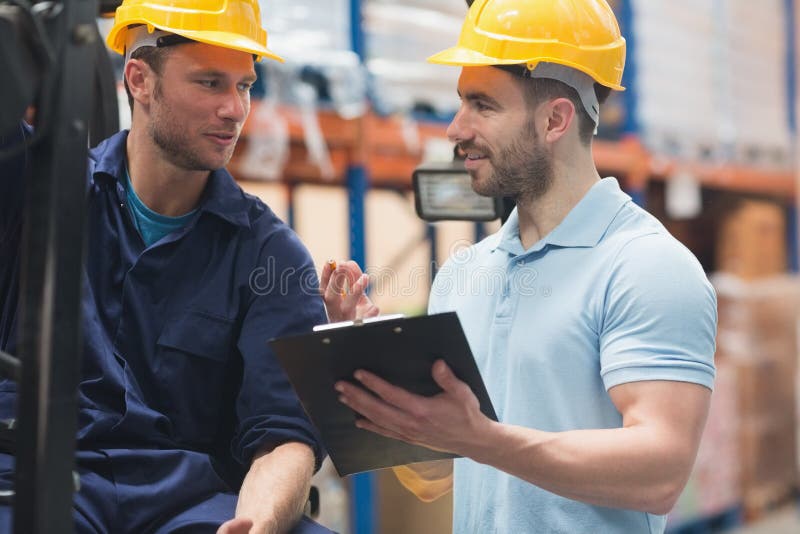 Smiling Warehouse Workers Talking Together Stock Image - Image of ...