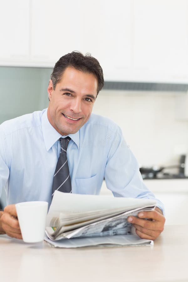 Smiling Well Dressed Man with Coffee Cup and Newspaper in Kitchen Stock ...