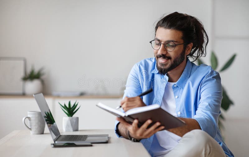 Smiling Western Freelancer Guy Taking Notes at Workplace in Home Office ...