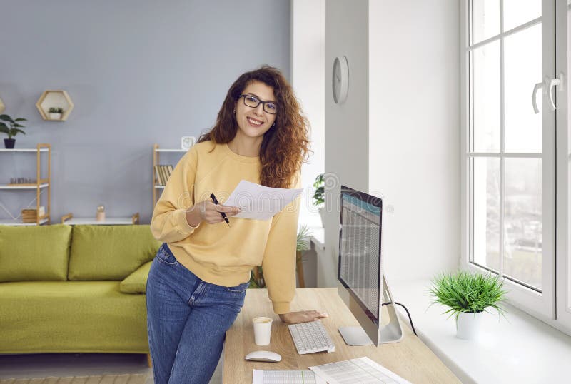 Smiling Woman Analyst Working With Paper Documents And Spreadsheet
