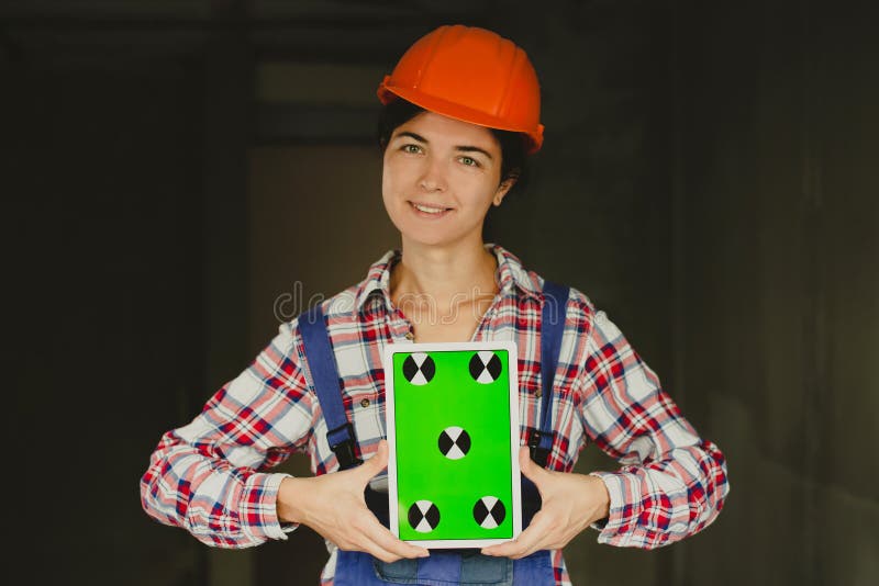 Smiling Woman Construction Manager Holding Tablet Device with Green ...