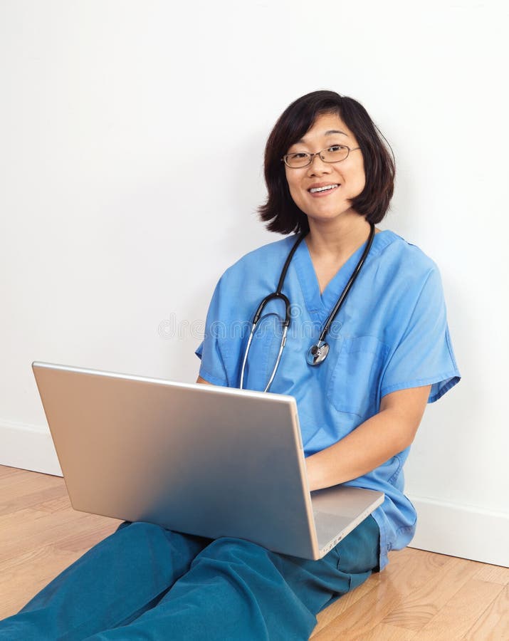 Portrait of Female Nurse Working at Nurses Station Stock Photo - Image ...