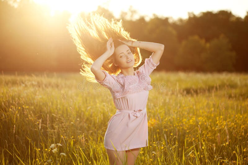 Smiling Woman in a Field at Sunset Stock Photo - Image of carefree ...