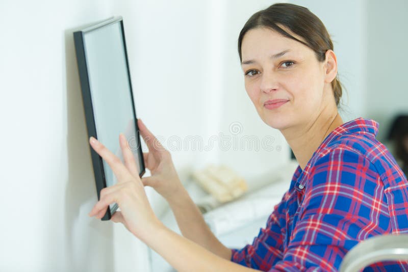 Smiling Woman Hanging Wall Frame Stock Image - Image of casual, wall ...