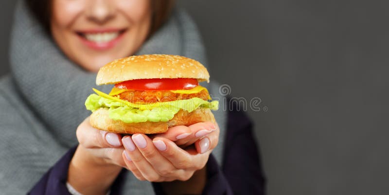 Smiling Woman Holding Burger in Two Hands. Stock Photo - Image of young ...