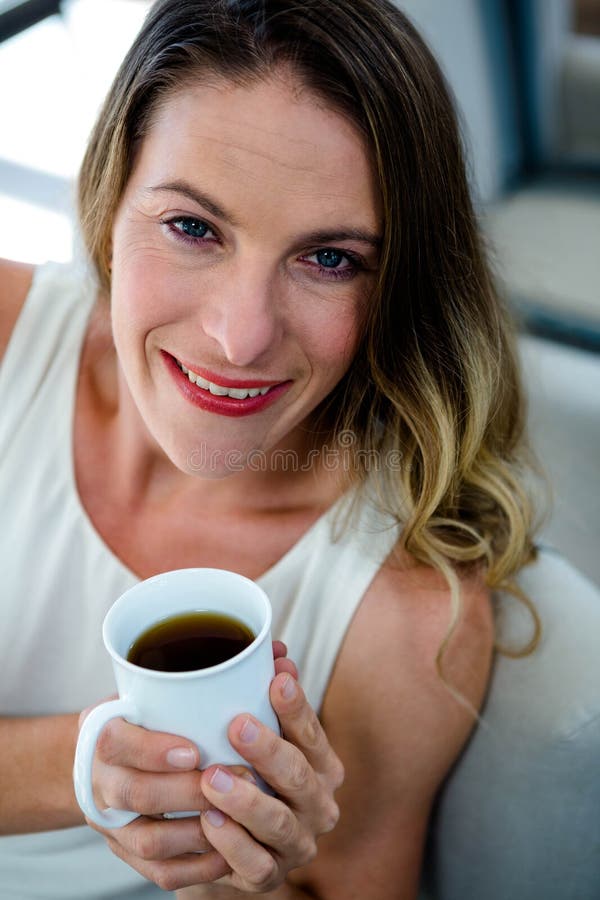 Smiling Woman Holding a Cup of Coffee Stock Photo - Image of lounge ...