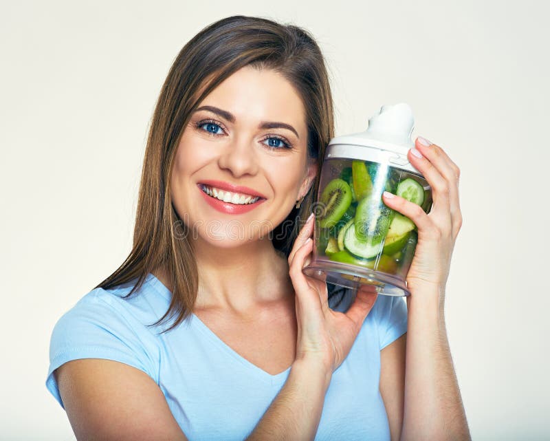 Smiling Woman Holding Green Ingredients For Smoothie In Blender Stock