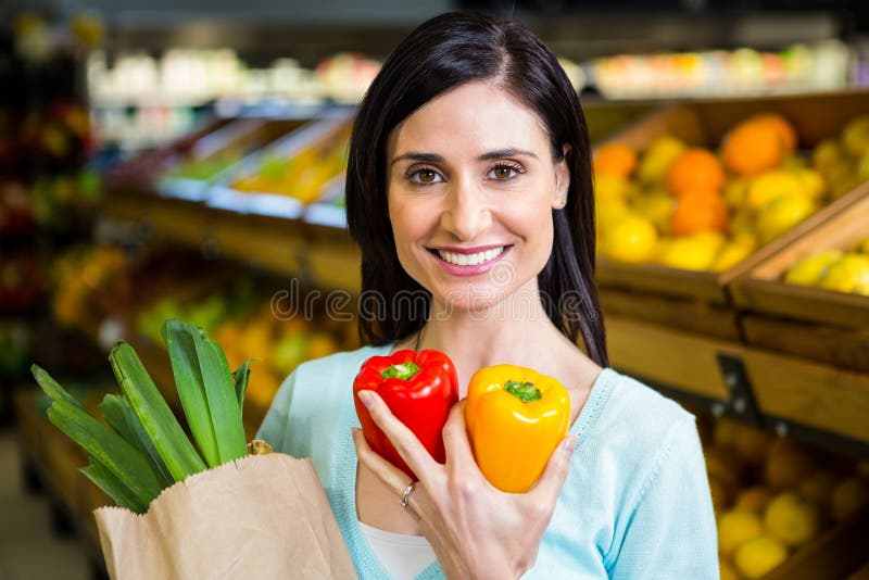 Smiling Woman Holding Pepper and Grocery Bag Stock Photo - Image of ... Smiling Woman Holding Pepper and Grocery Bag Stock Photo - Image of ...