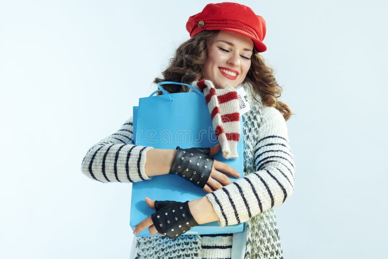 Smiling Woman Hugging Blue Shopping Bag With Purchased Sweater Stock
