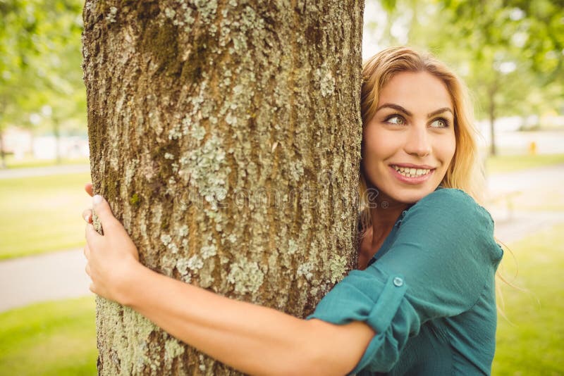 Smiling woman hugging tree stock photo. Image of leisure - 60554276