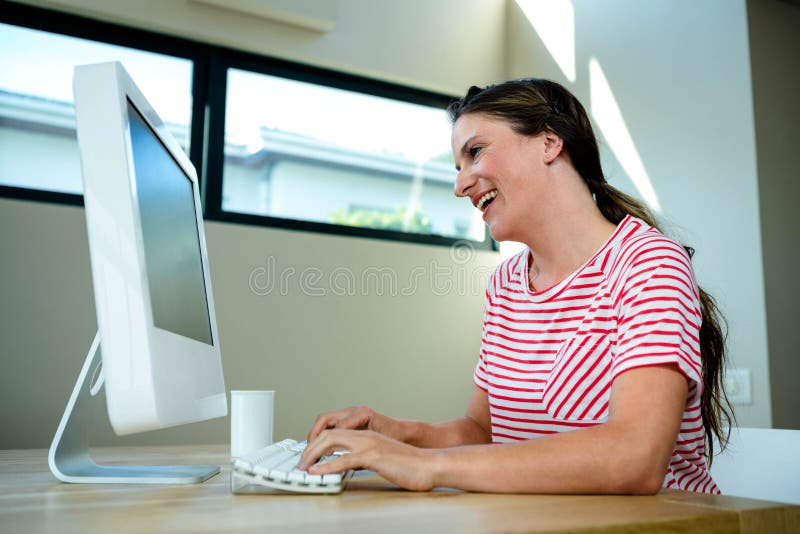 Smiling Woman Laughing at Her Computer Stock Image - Image of mouse ...