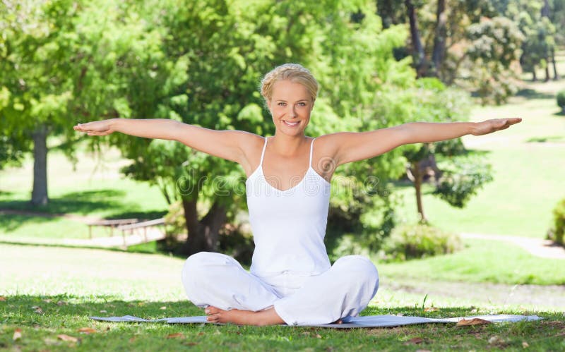 Smiling Woman on the Lawn Doing Yoga Exercises Stock Image - Image of ...