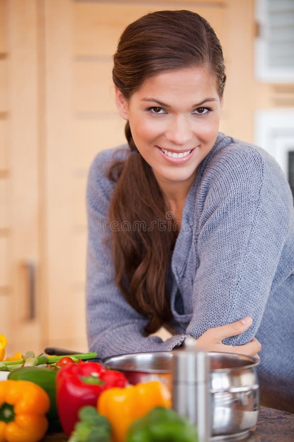 Smiling Woman Leaning Against the Kitchen Counter Stock Photo - Image ...