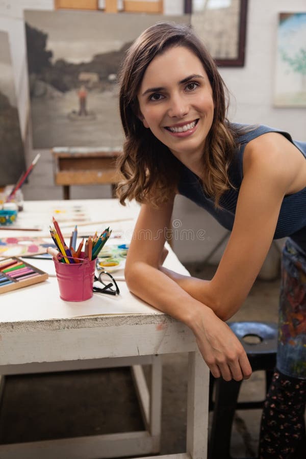 Smiling Woman Leaning at Table in Drawing Class Stock Photo - Image of ...