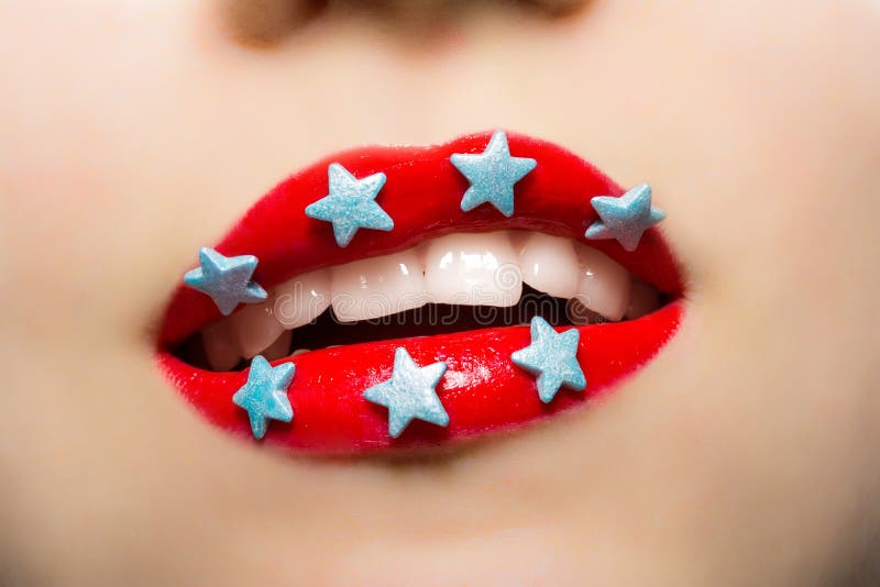 Woman with Lips Painted Red Lipstick and Candy Stars Macro. Kiss To the ...