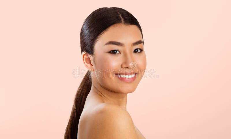 Smiling Woman With Long Black Hair Against Pink Background Stock Image