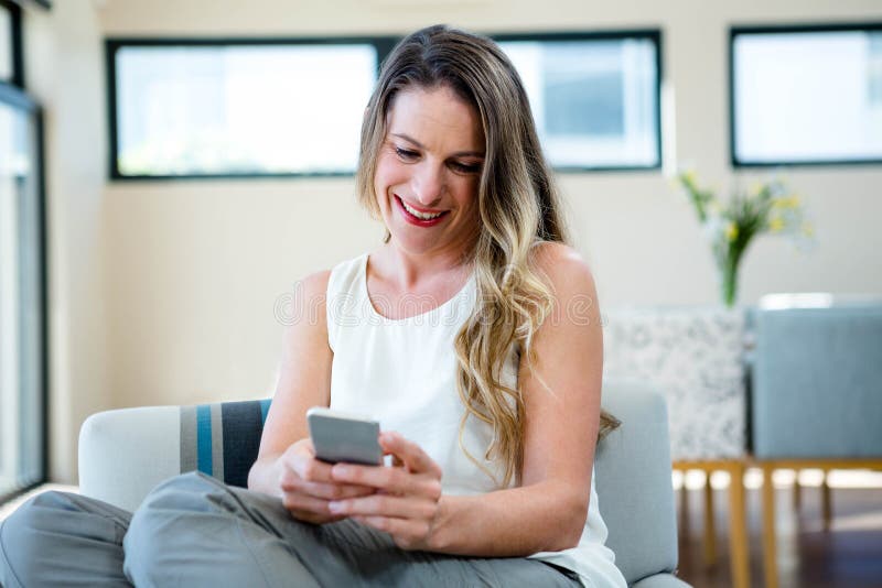 Smiling Woman Looking at Her Mobile Phone Stock Image - Image of ...